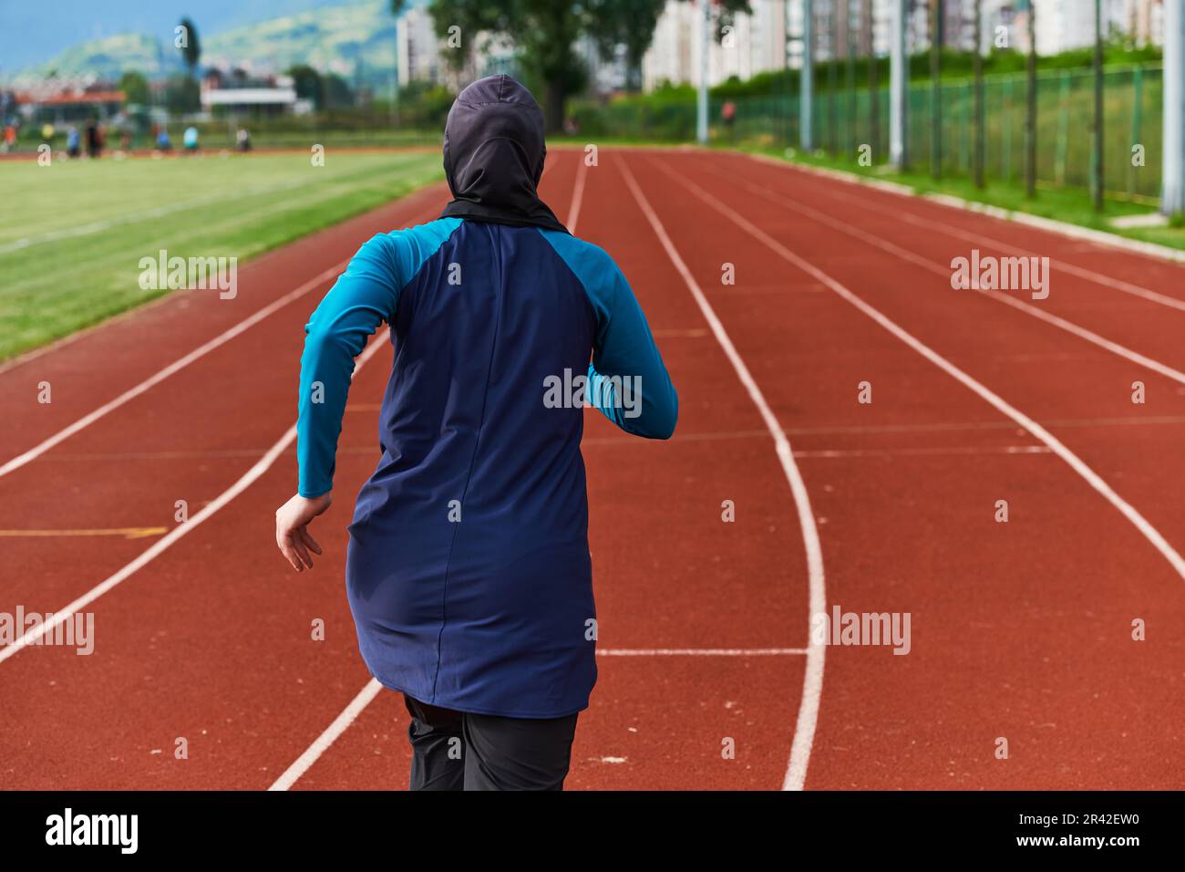 A muslim woman in a burqa sports muslim clothes running on a marathon ...