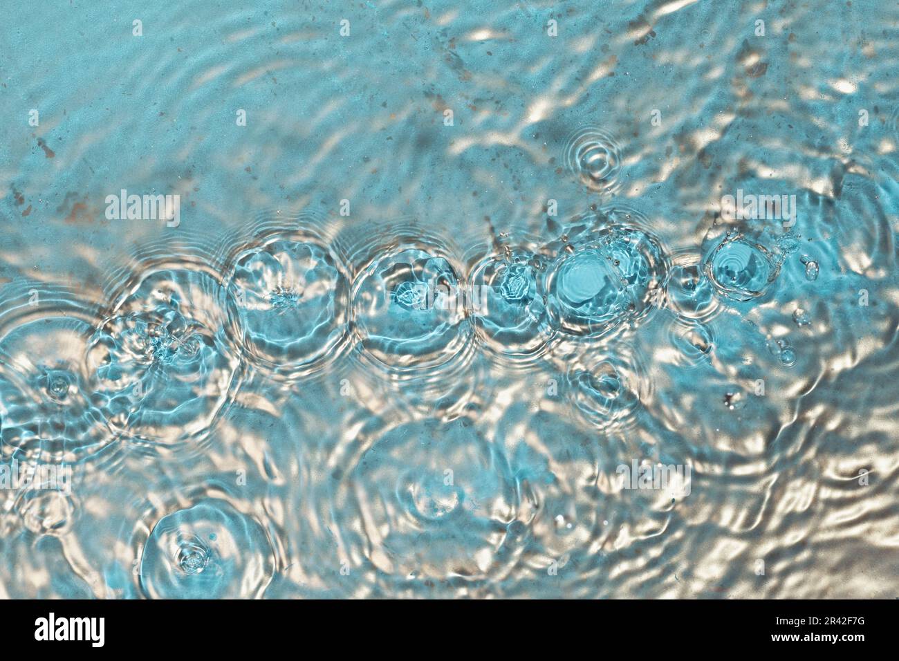 Cosmetic moisturizer micellar water. Gold powder particles forms on ...