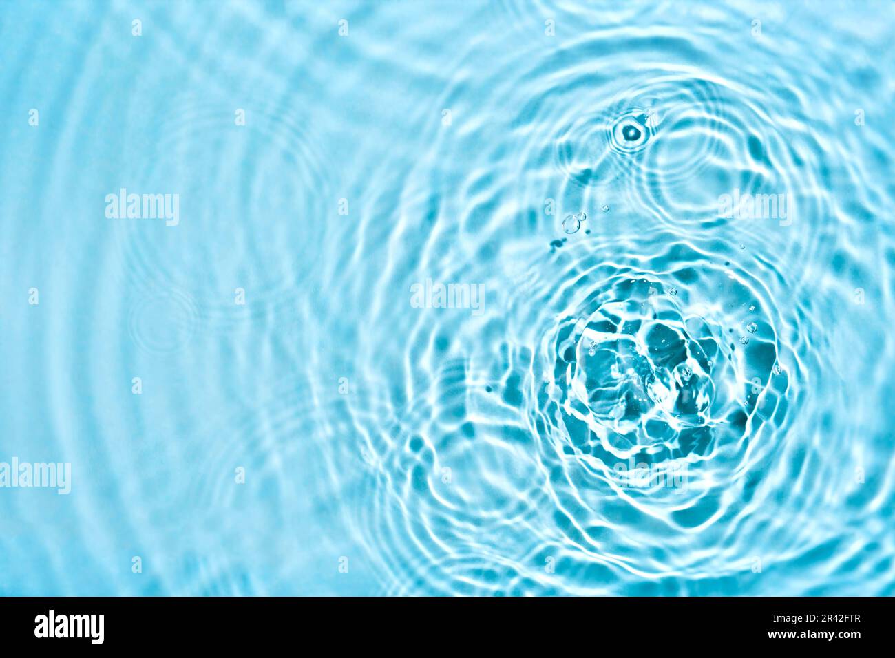 Abstract transparent liquid background with concentric circles and ...