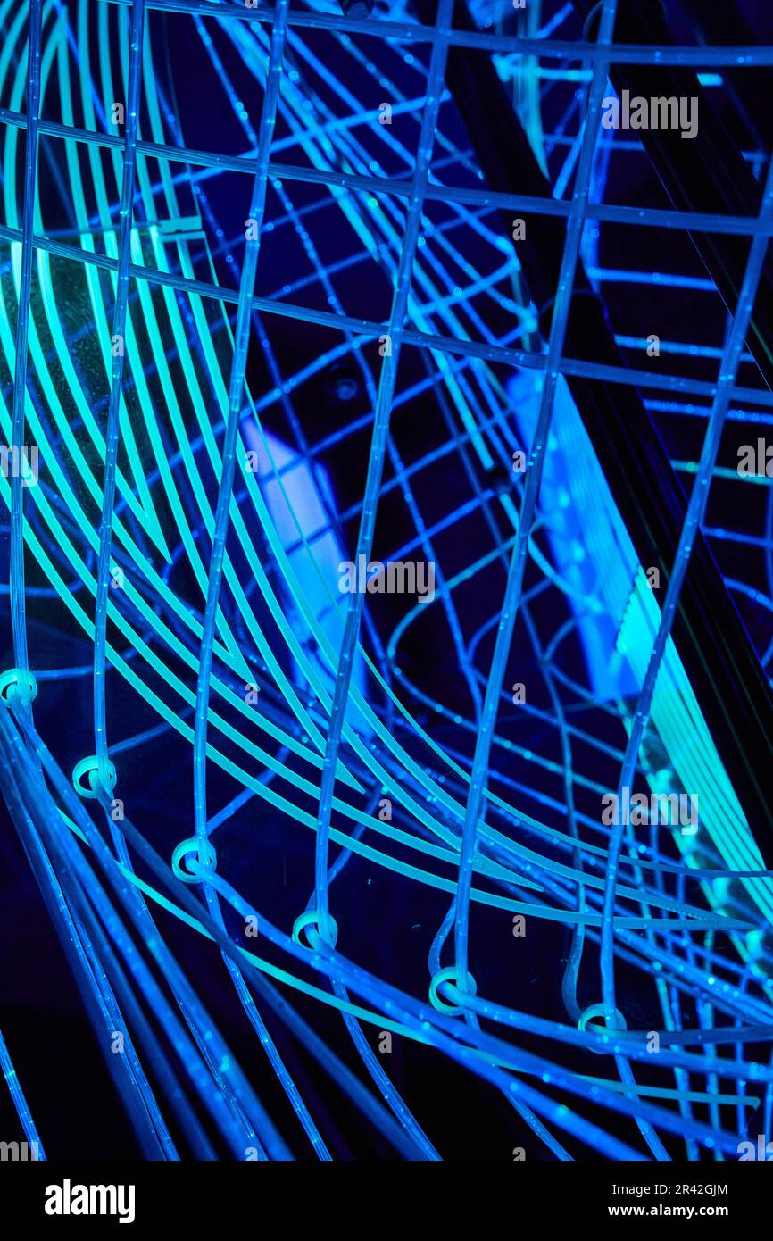 Tangled web of wires of blue LED neon lights with black background ...