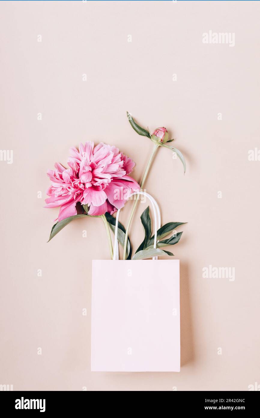 Beautiful pink peony in paper bag. Sale, shopping and eco-friendly ...