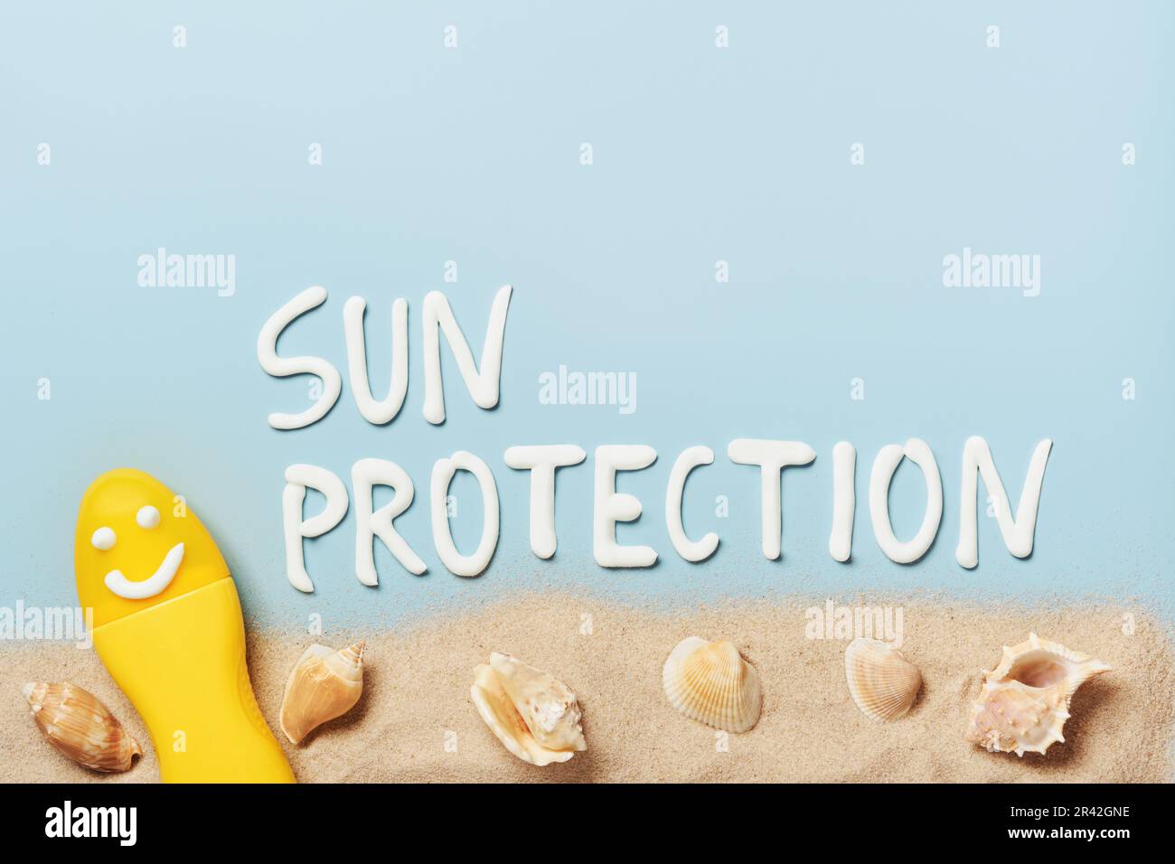 Yellow tube with happy sunscreen face with SUN PROTECTION word on blue ...