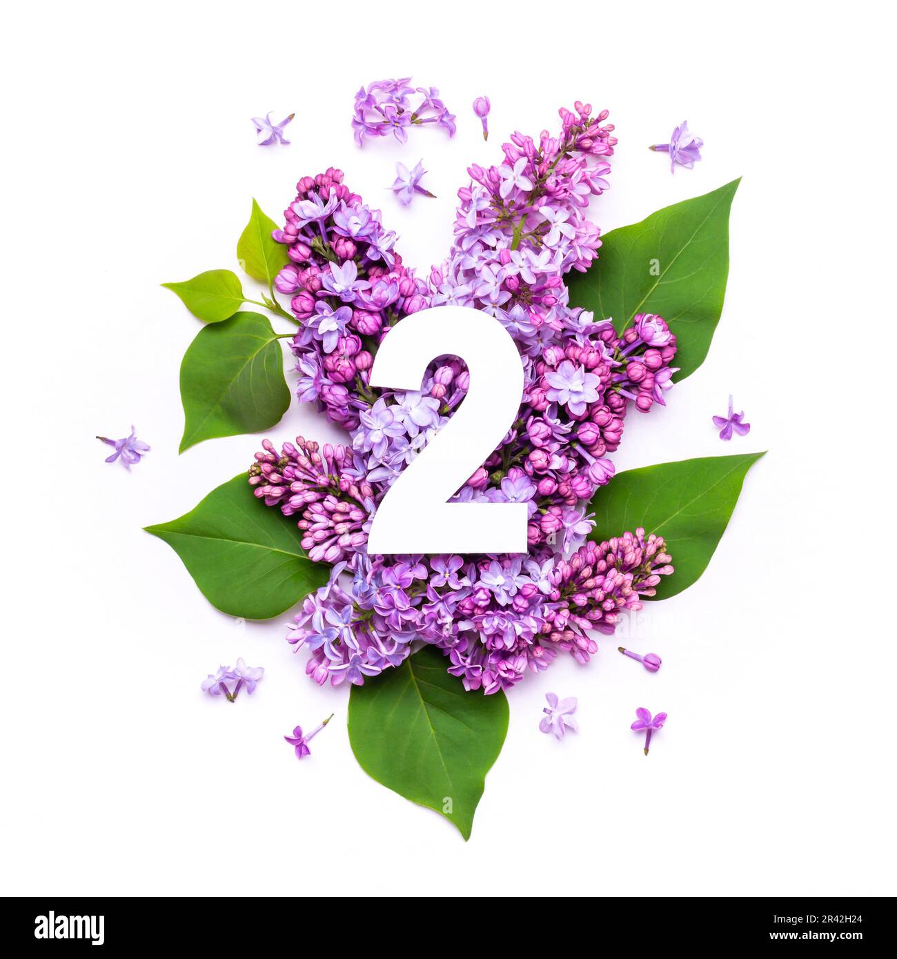 Paper number two on background of lilac flowers. Minimal creative ...