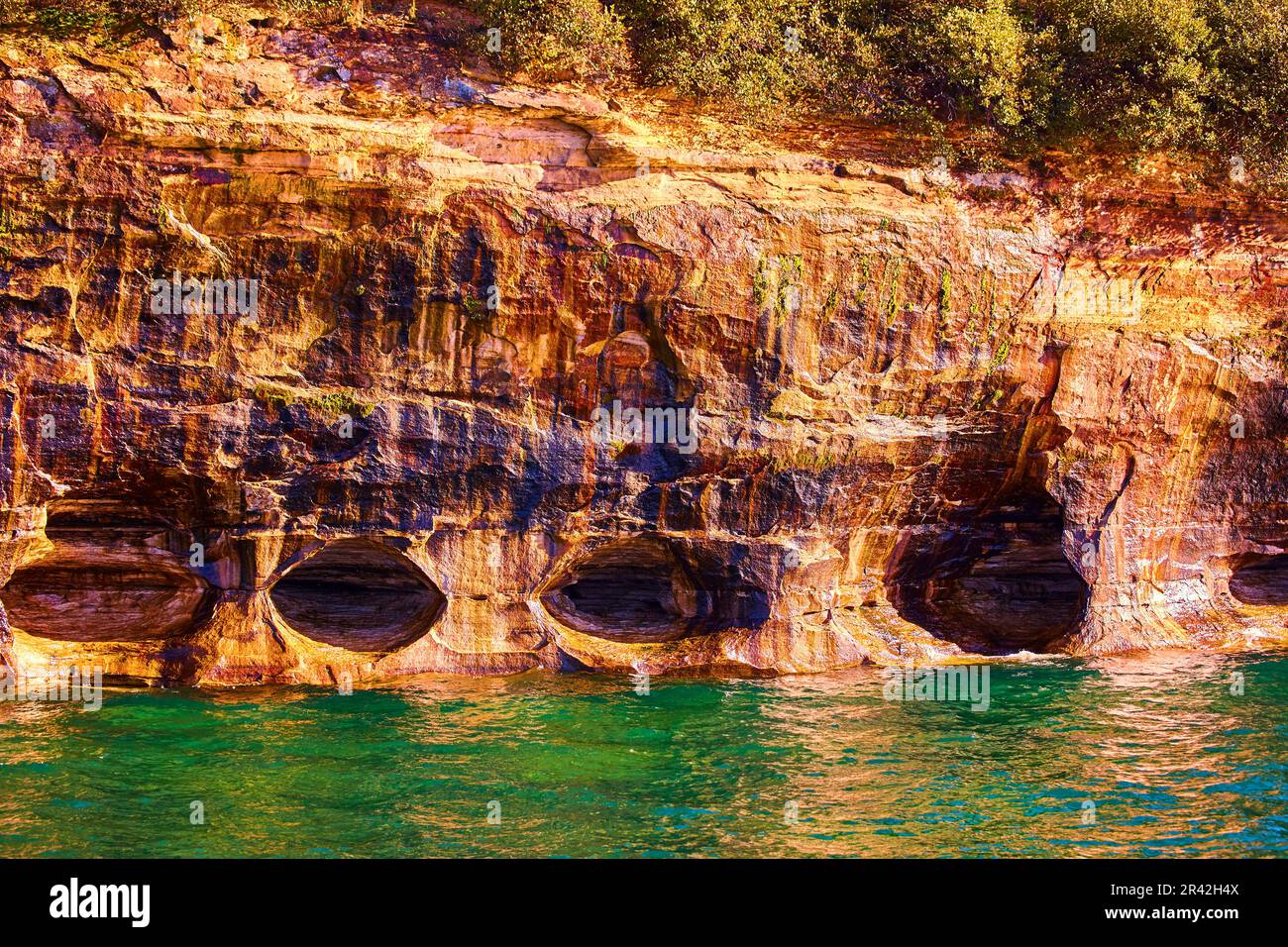 Turquoise water and ominous caves and hollow cliff side cavers Pictured ...