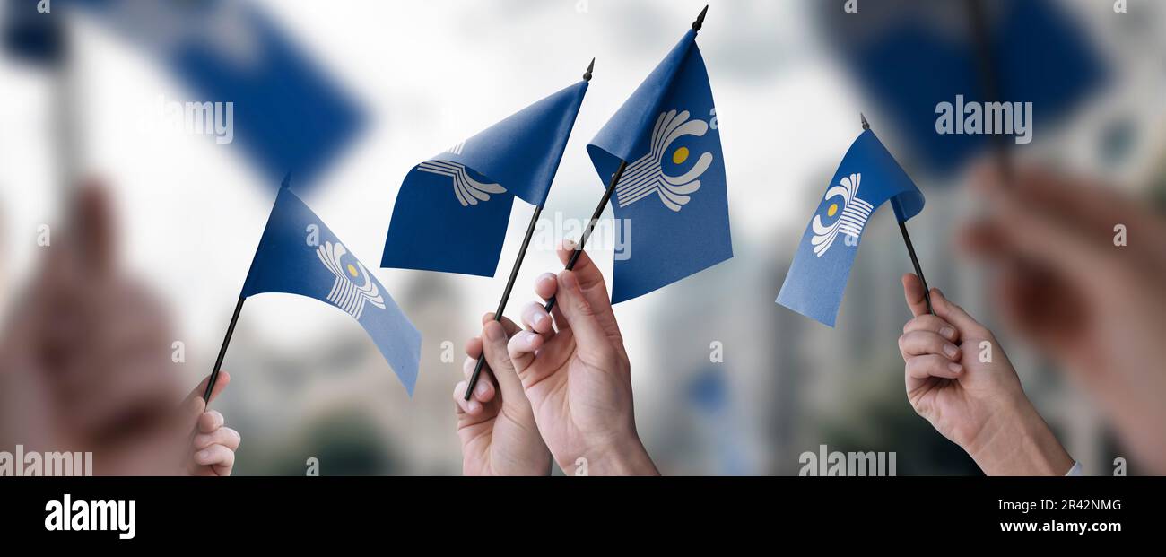 A group of people holding small flags of the CIS in their hands Stock ...