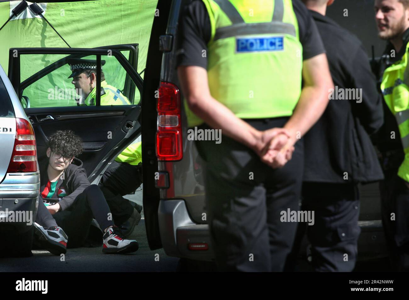Behind a screen, protesters from Palestine Action block vehicle access ...