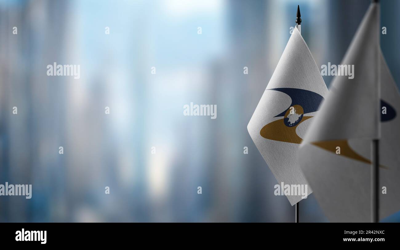 Small flags of the Eurasian Economic Union on an abstract blurry ...