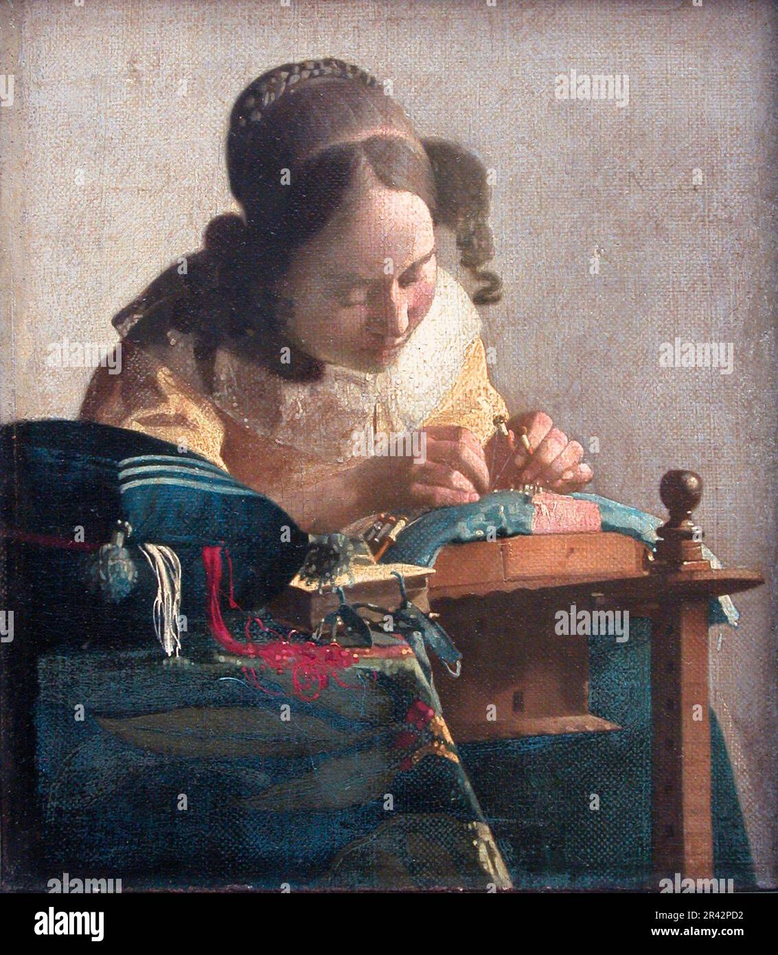 The Lacemaker painted by the Dutch Golden Age painter Johannes Vermeer ...