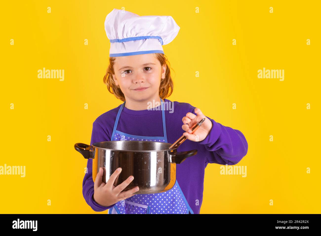 Kid cook with cooking pot and ladle. Child wearing cooker uniform and ...