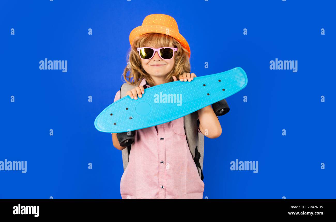 Child with skateboard in the studio. Kid having fun with penny board ...