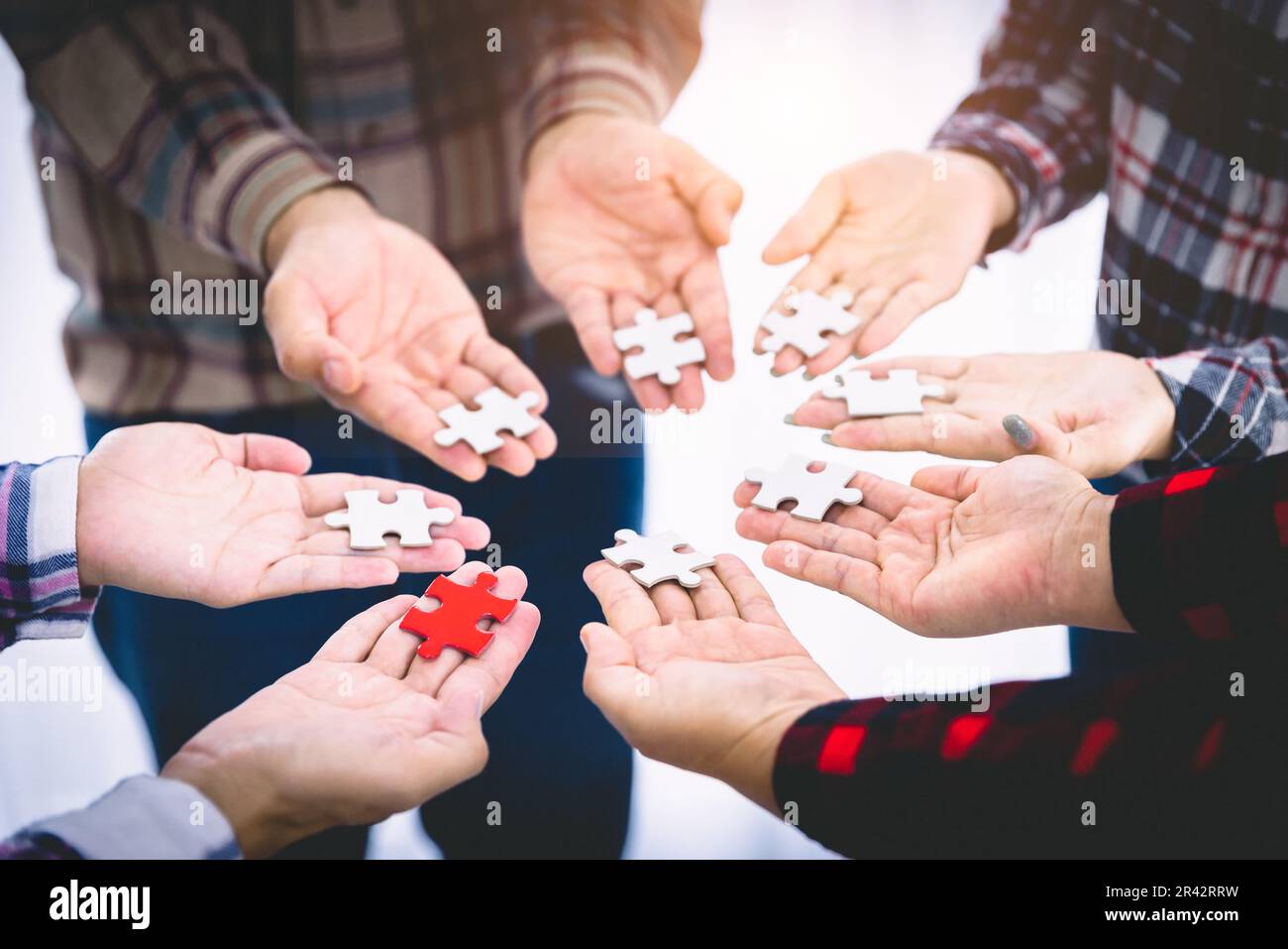 Business team is connecting puzzle pieces, unity, cooperation, teamwork ...