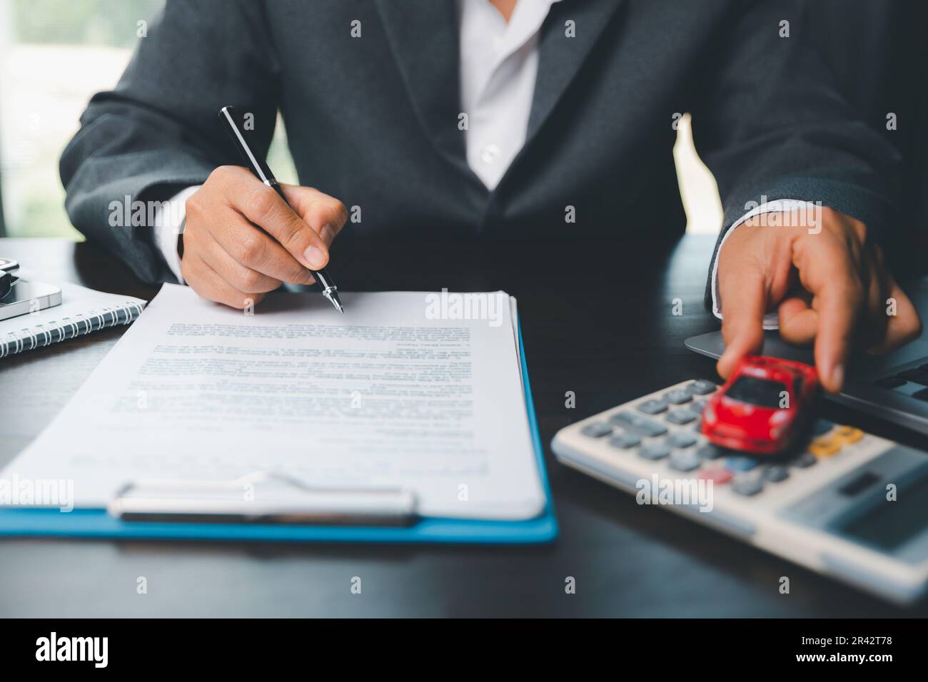 Car dealer business woman signing car insurance document or lease paper ...