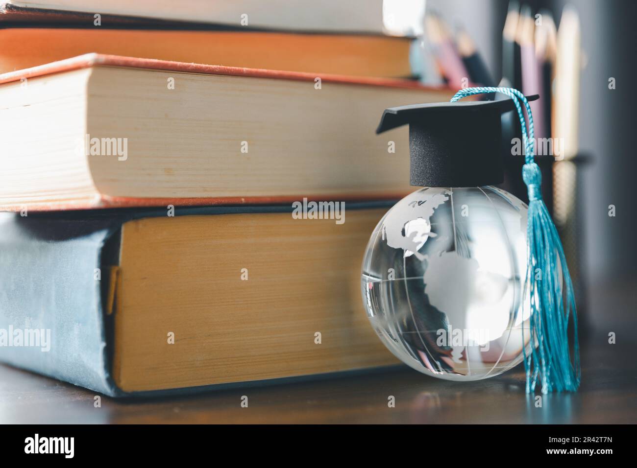Graduate study abroad program concept : Black graduation cap on a globe ...