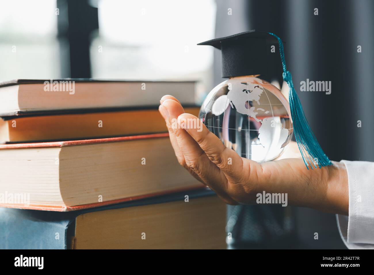 Graduate study abroad program concept : Black graduation cap on a globe ...