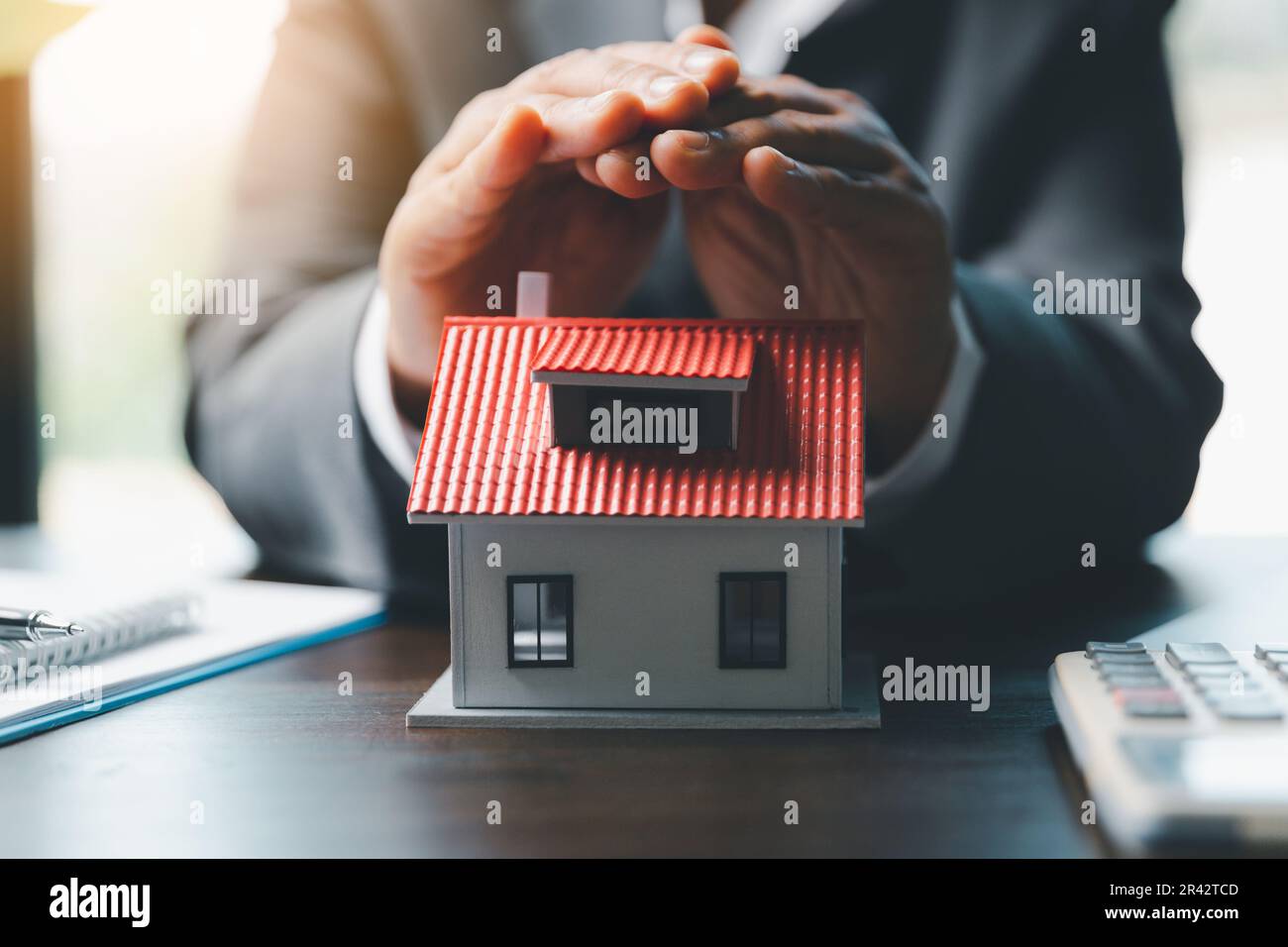 Female hands saving small house with a roof. insurance protective hand ...