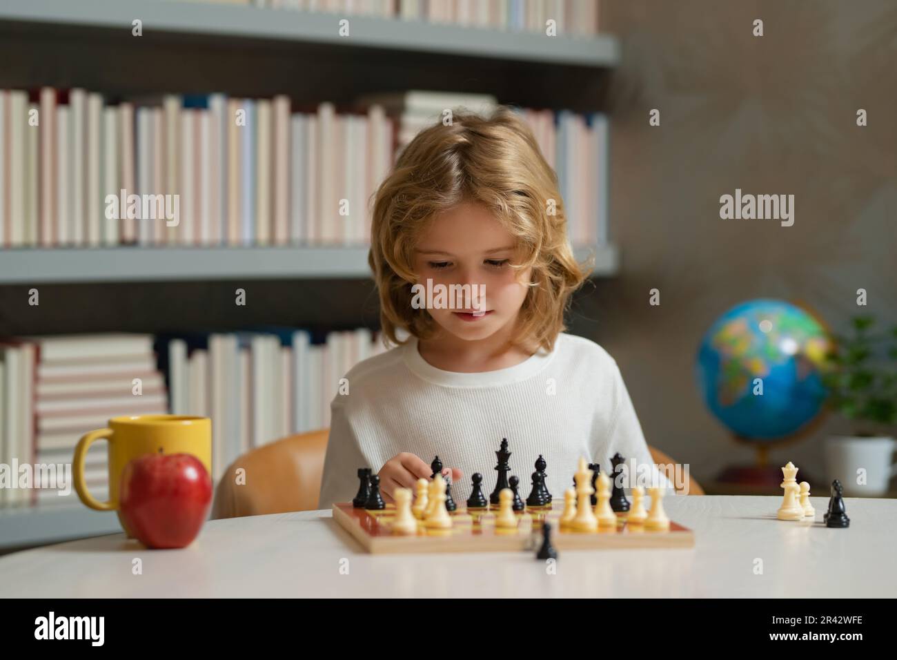 Clever concentrated and thinking child playing chess Stock Photo - Alamy
