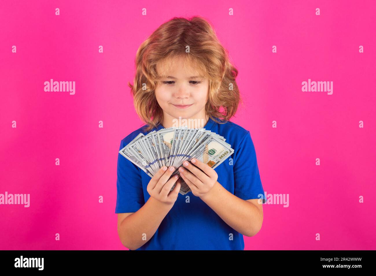 Money win, big luck. Happy rich kid boy with money dollars cash Stock ...