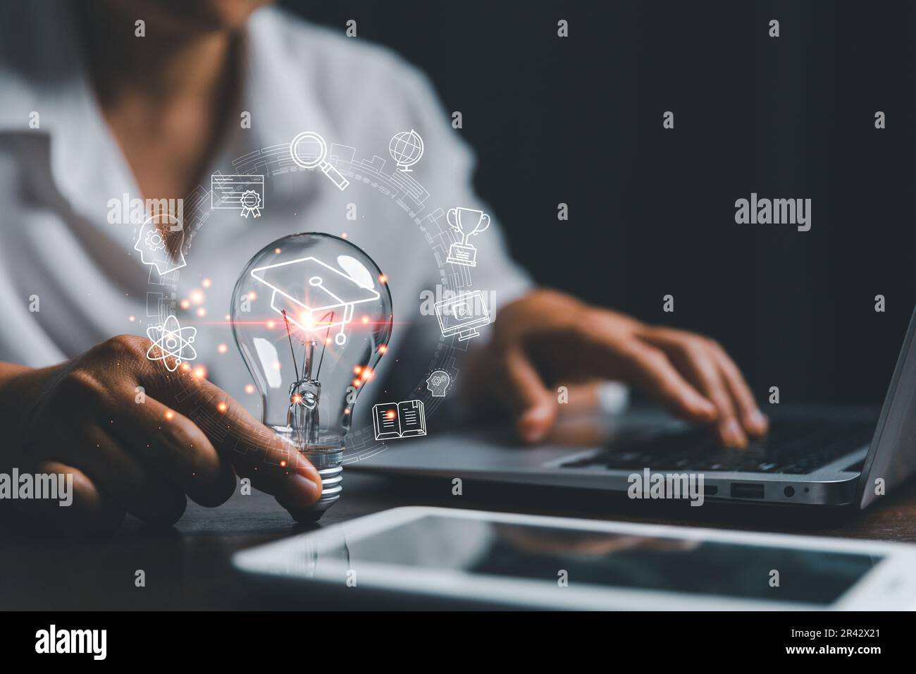 Female holding lightbulb showing graduation hat, Internet education ...