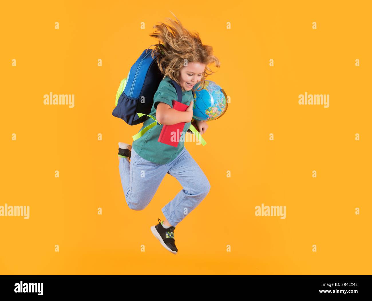 Kid jump and enjoy school. School boy in school uniform with backpack ...