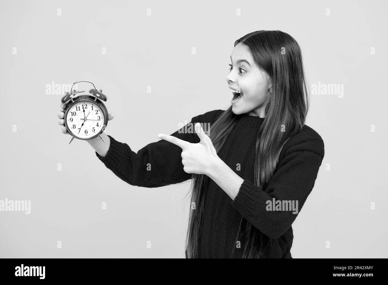 Excited face. Portrait of teenage girl with clock alrm, time and ...