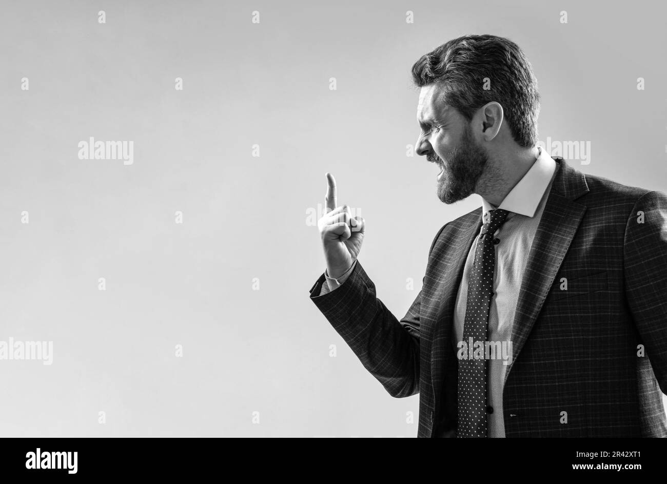 Angry broker man in formal wear sideway keep finger raised grey ...