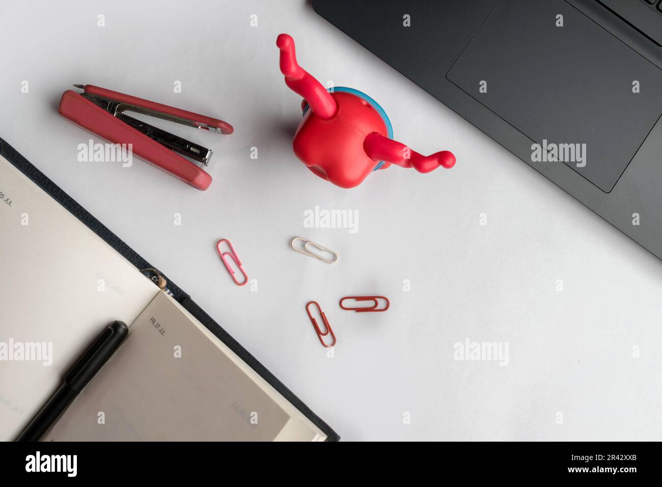 Flat lay design of work desk with notebook, pen, laptop, stapler, paper ...