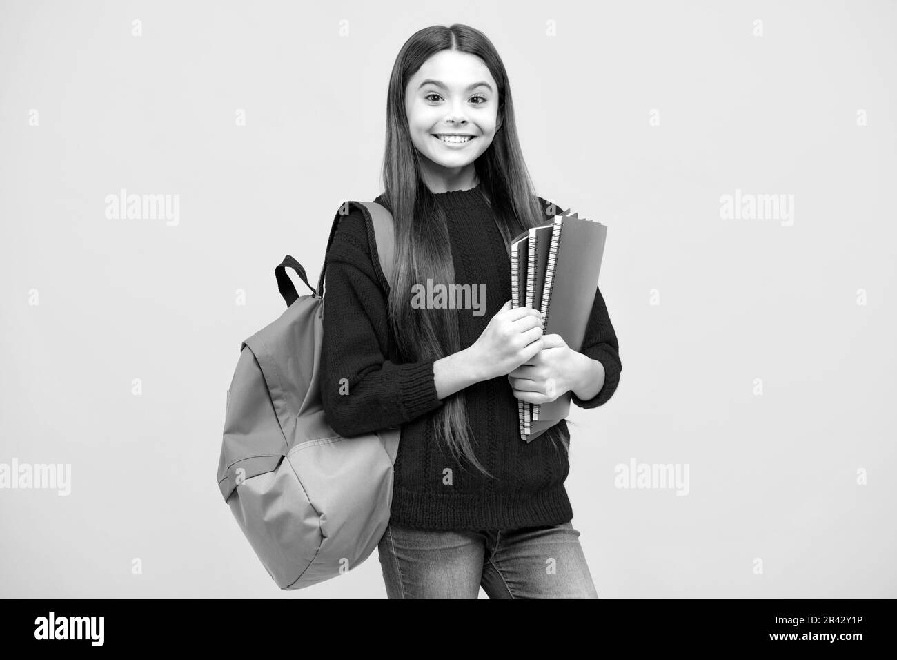 Back to school. Schoolgirl student hold book on yellow isolated studio ...