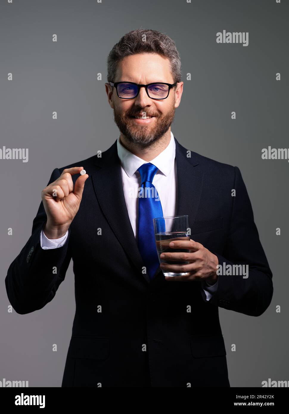 Happy man taking a medicine pill from headache migraine Stock Photo - Alamy