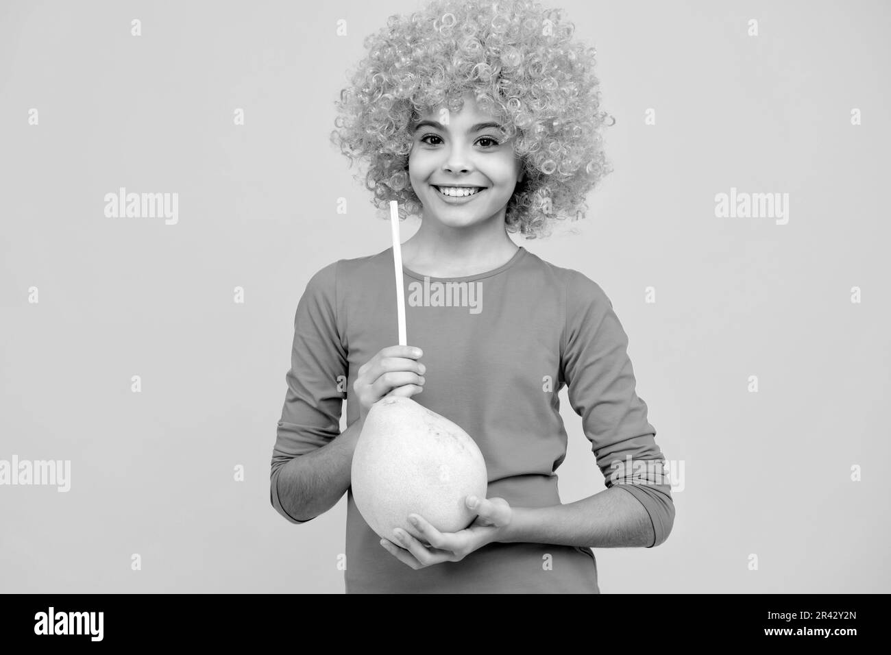 Teenager child girl hold citrus fruit pummelo or pomelo full of vitamin ...