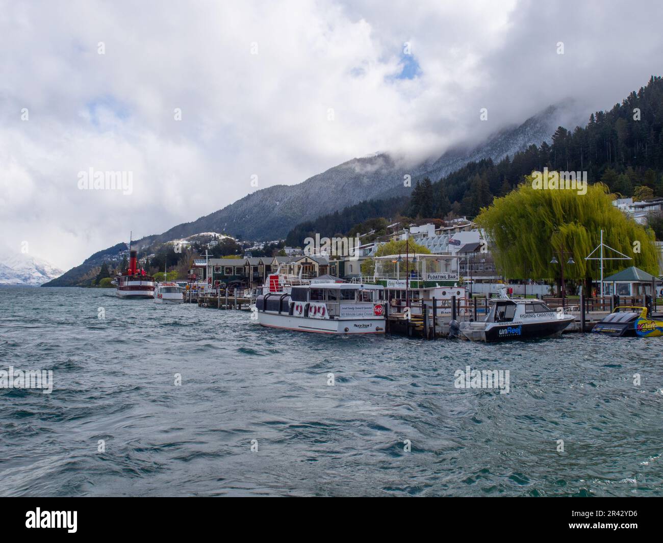 Boats Moored Around The Waterfront In Queenstown Stock Photo - Alamy