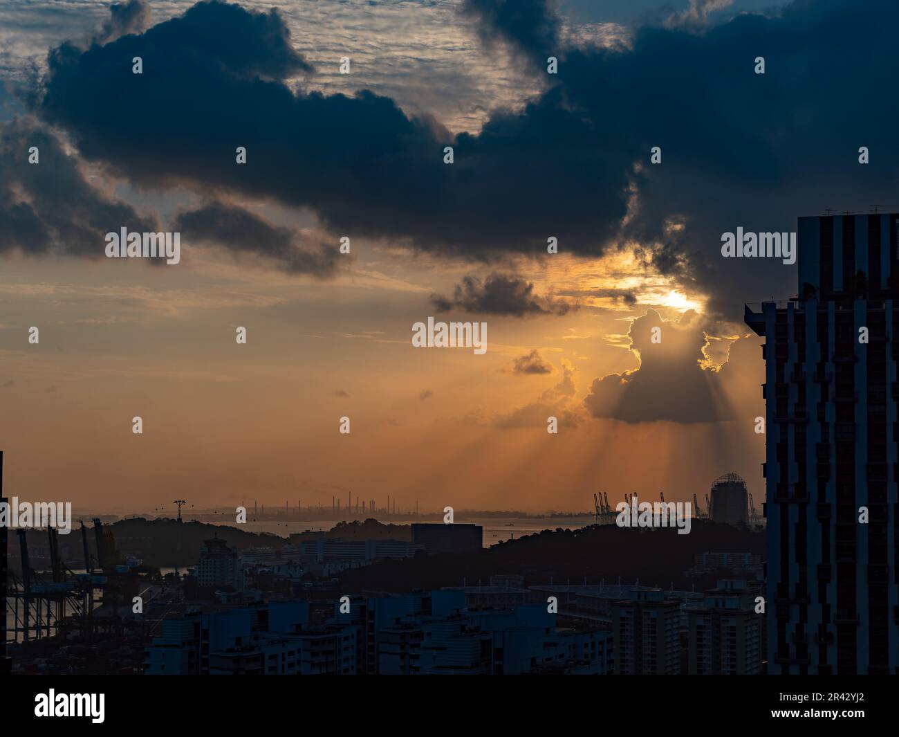 Dark and cloudy sunset in Singapore with the contours of harbour and ...