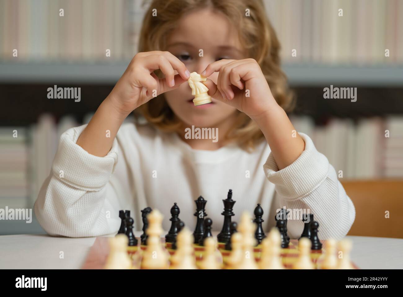 Little kid chessman play chess game, checkmate. Child playing chess in ...