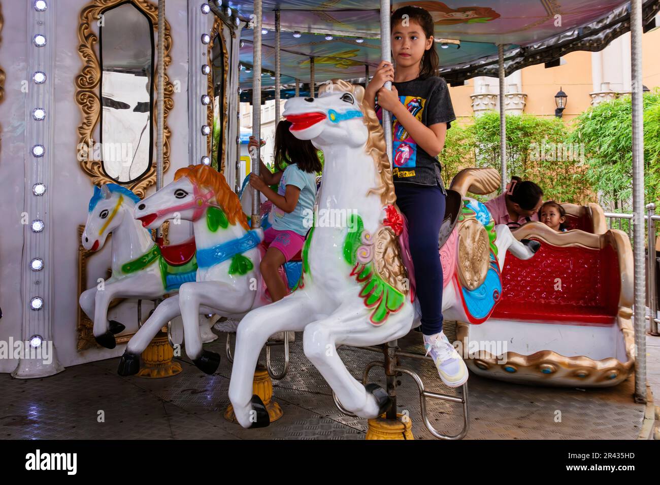 Young Philippina girl on carousel, Venice Grand Canal Mall, Taguig City ...