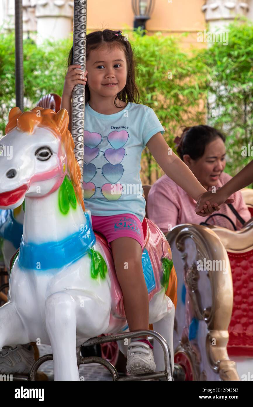 Young Philippina girl on carousel, Venice Grand Canal Mall, Taguig City ...
