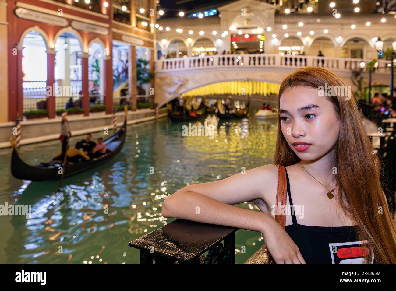Attractive young Philippina girl posing in front of gondolas, Venice ...