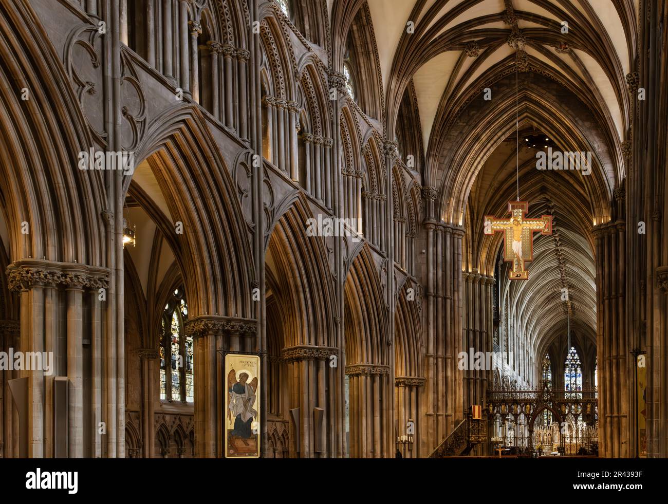 A cross bearing the image of Jesus is seen suspended from the vaulted ...
