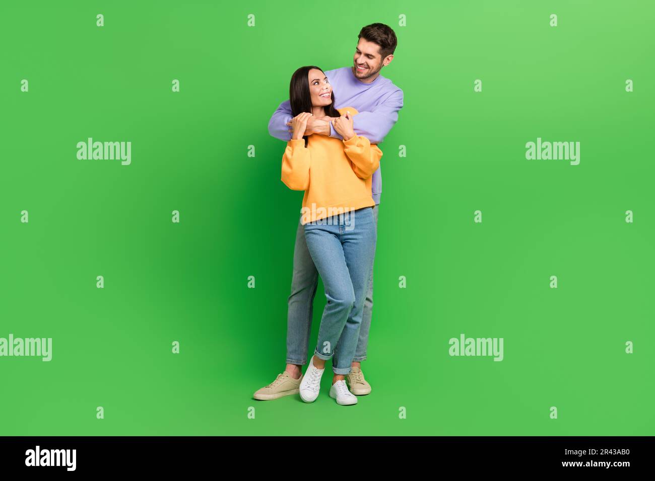 Full size photo of two cheerful lovely partners cuddle look each other ...