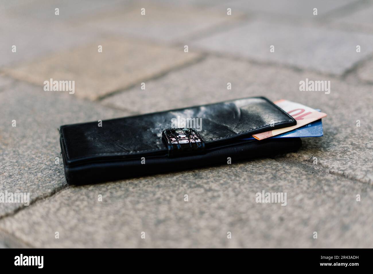 The wallet with coins on sidewalk street, forgotten money Stock Photo ...