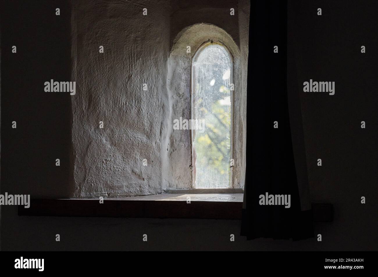 A narrow arched window on an old farmhouse Stock Photo - Alamy
