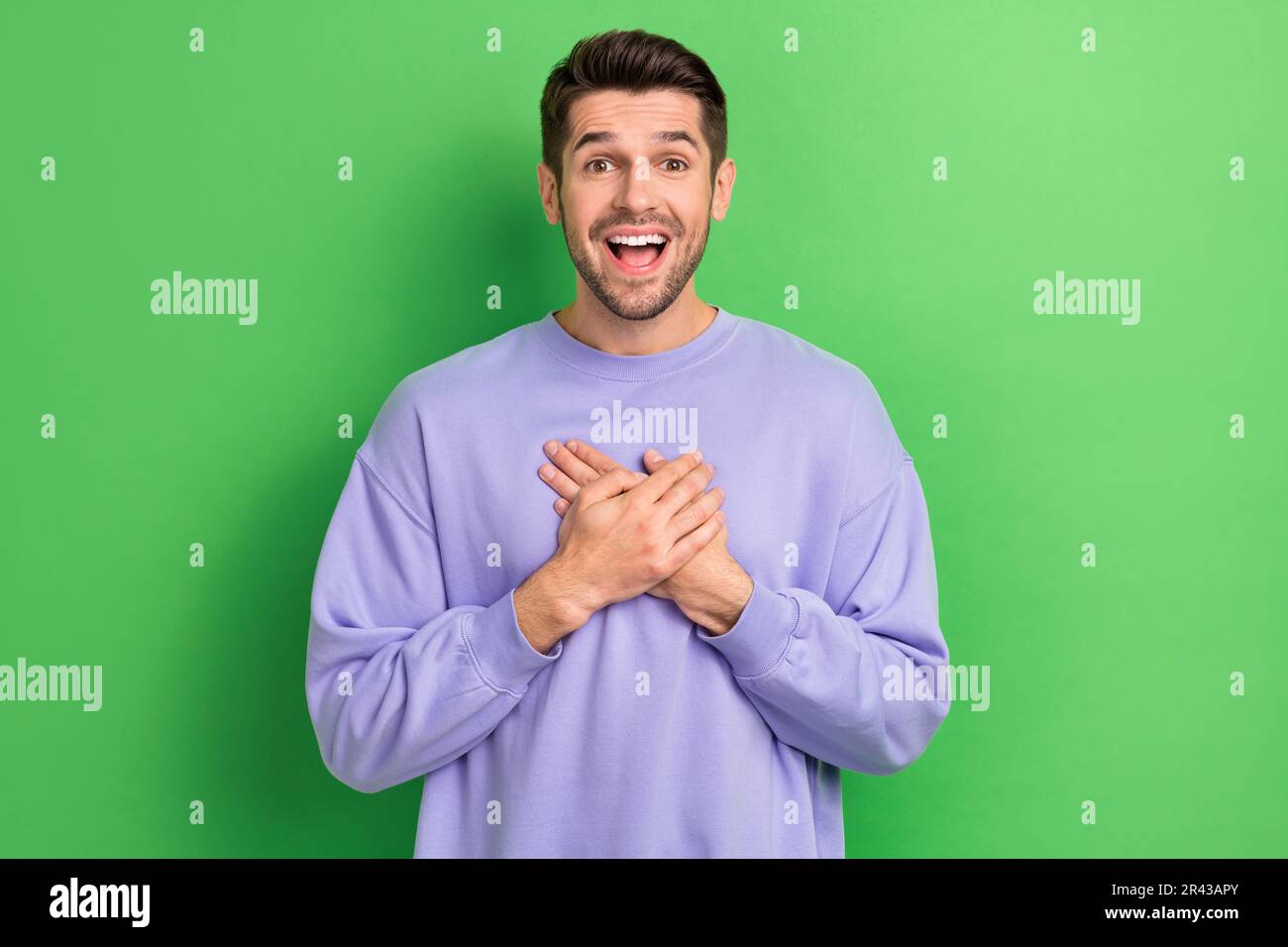 Portrait of impressed cheerful man arms touch chest open mouth isolated ...