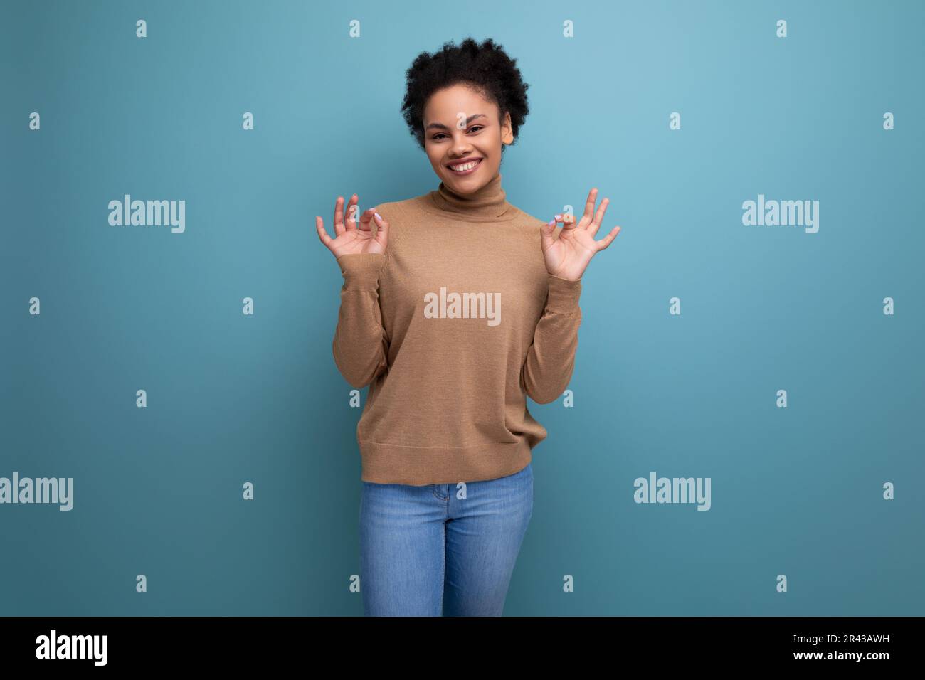 happy joyful young woman with swarthy skin and fluffy hair over ...