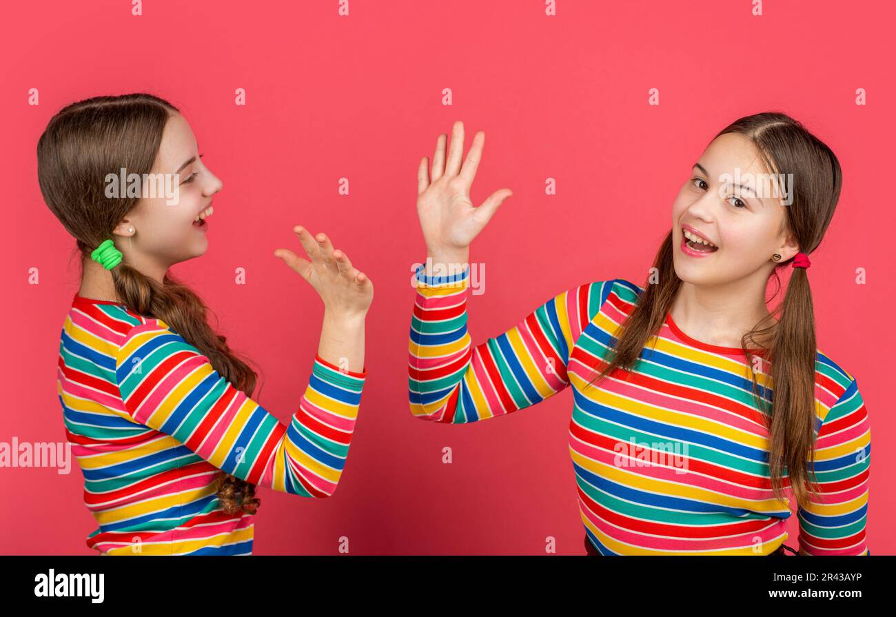happy children embracing on pink background. hello Stock Photo - Alamy