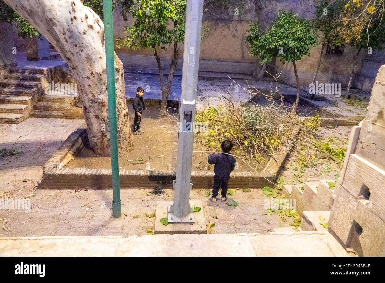 Shiraz, Iran - December 31, 2022: Children play in the yard with sawn ...
