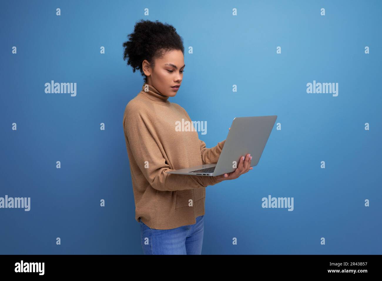 successful young female student with swarthy skin and fluffy hair ...