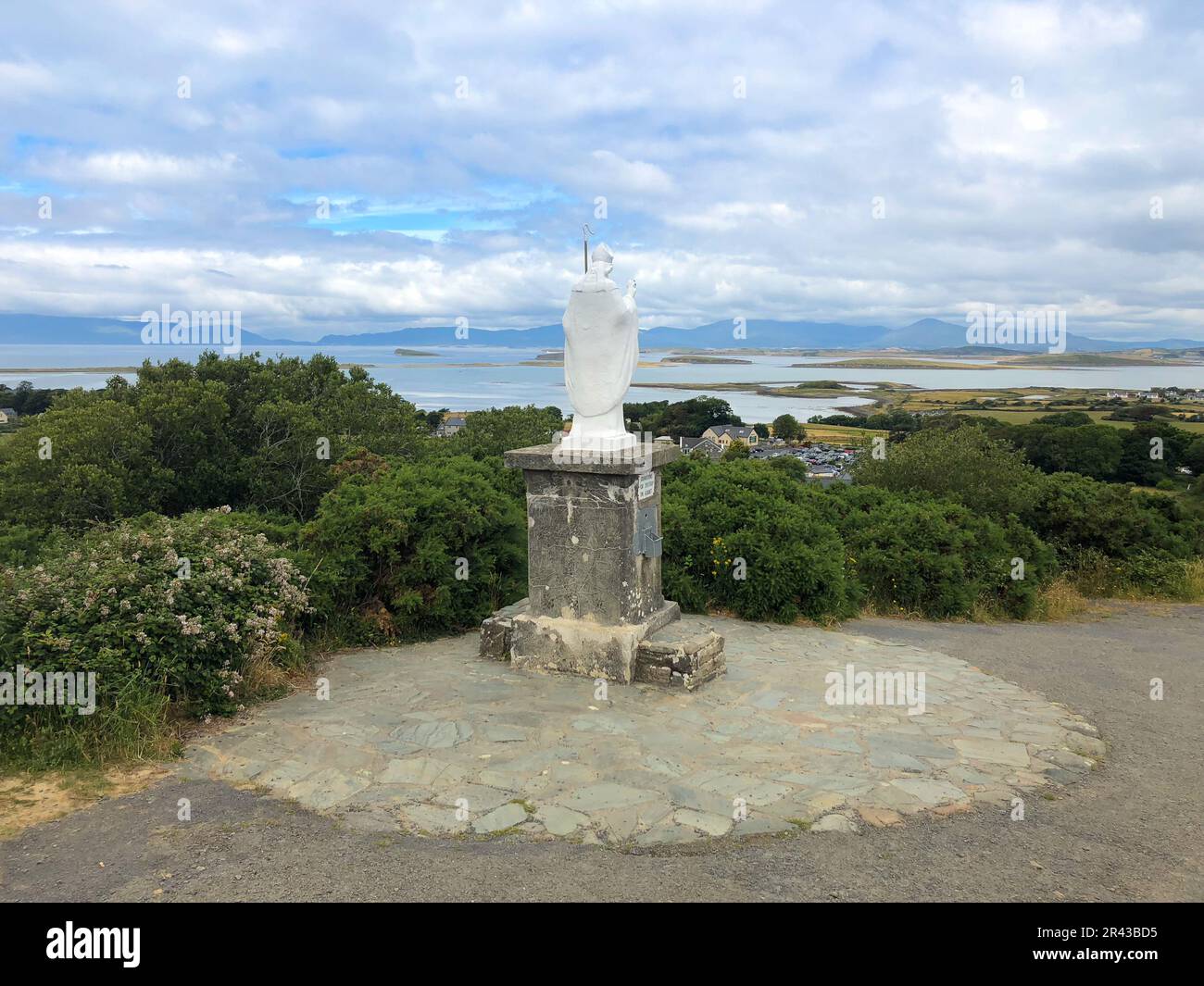 White statue of Saint Patrick at the start of foot path to the peak of ...
