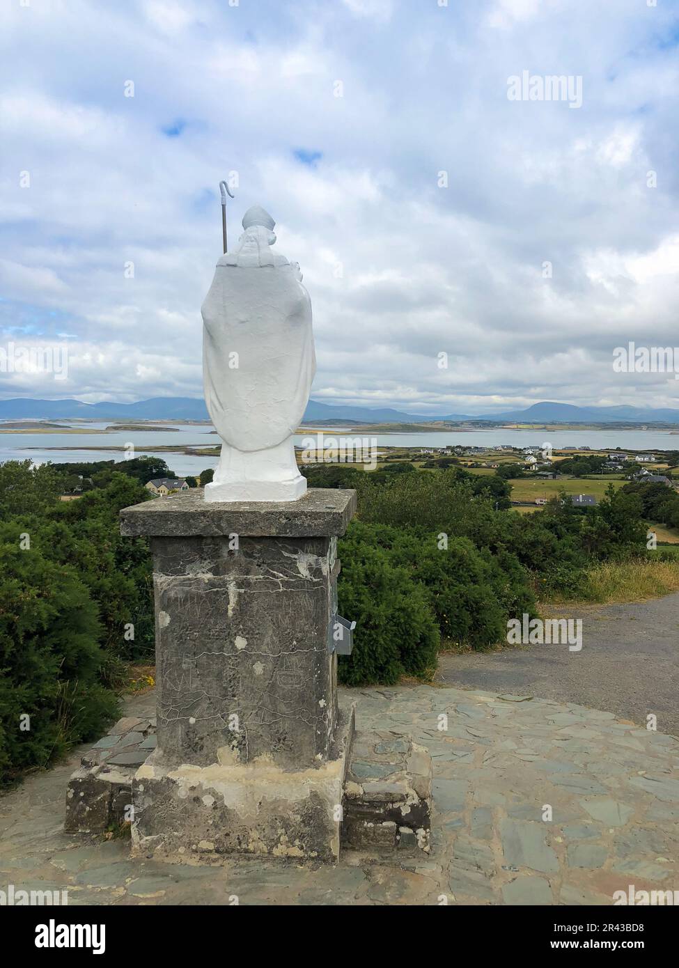 White statue of Saint Patrick at the start of foot path to the peak of ...