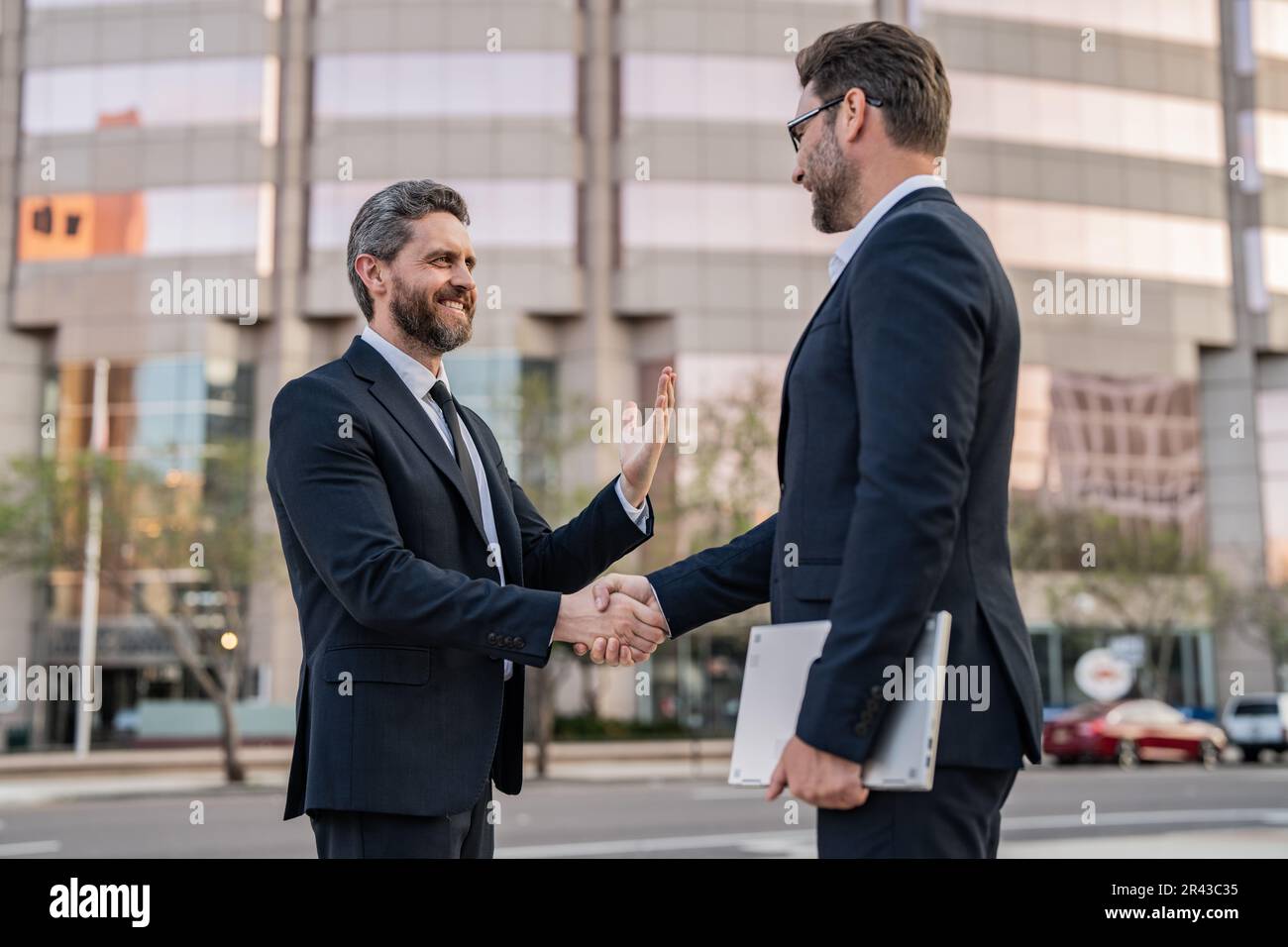 photo of positive two business men handshaking. two business men ...