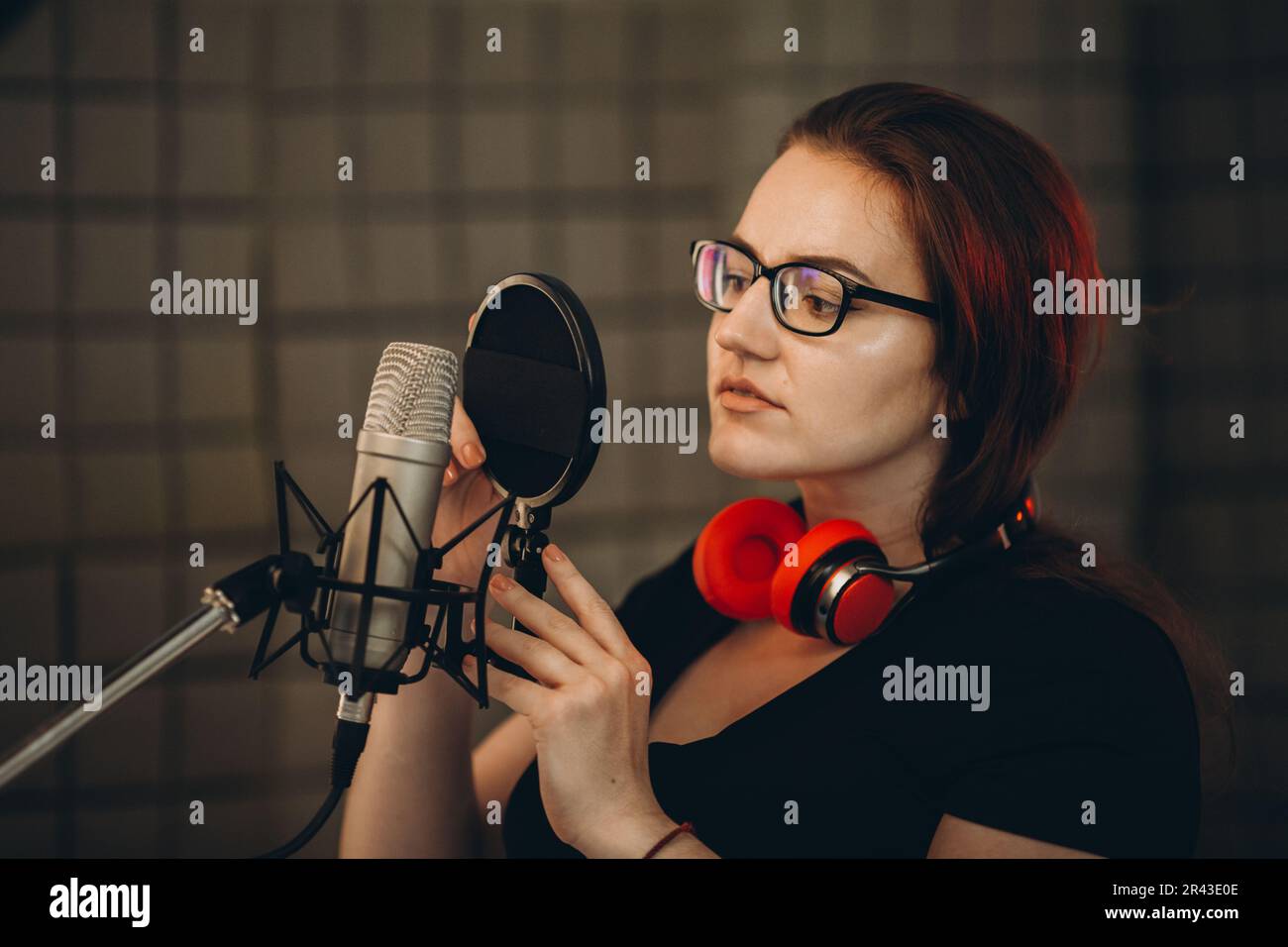 Female person records POP song at the recording studio. Singer ...