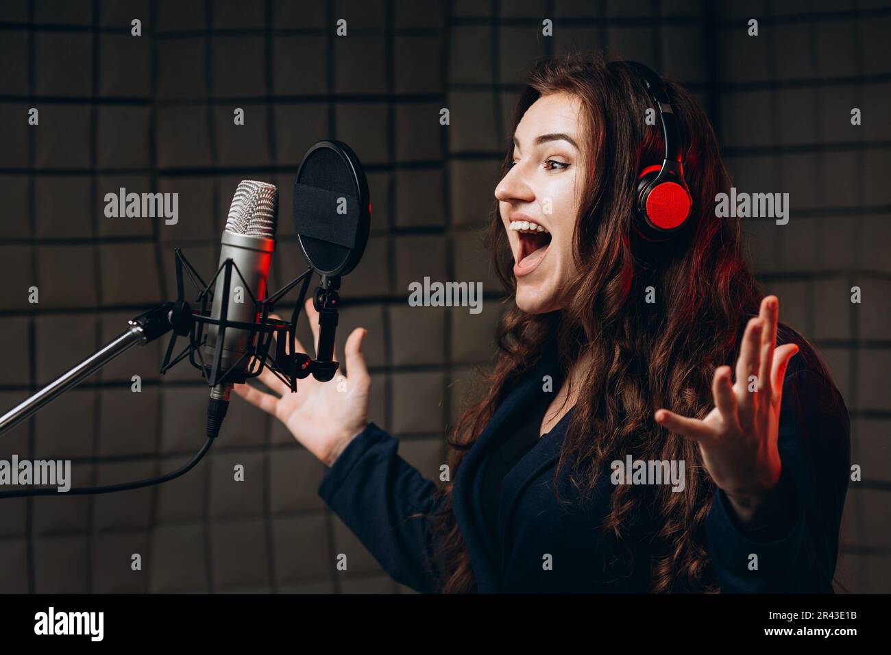 Female person records POP song at the recording studio. Singer ...