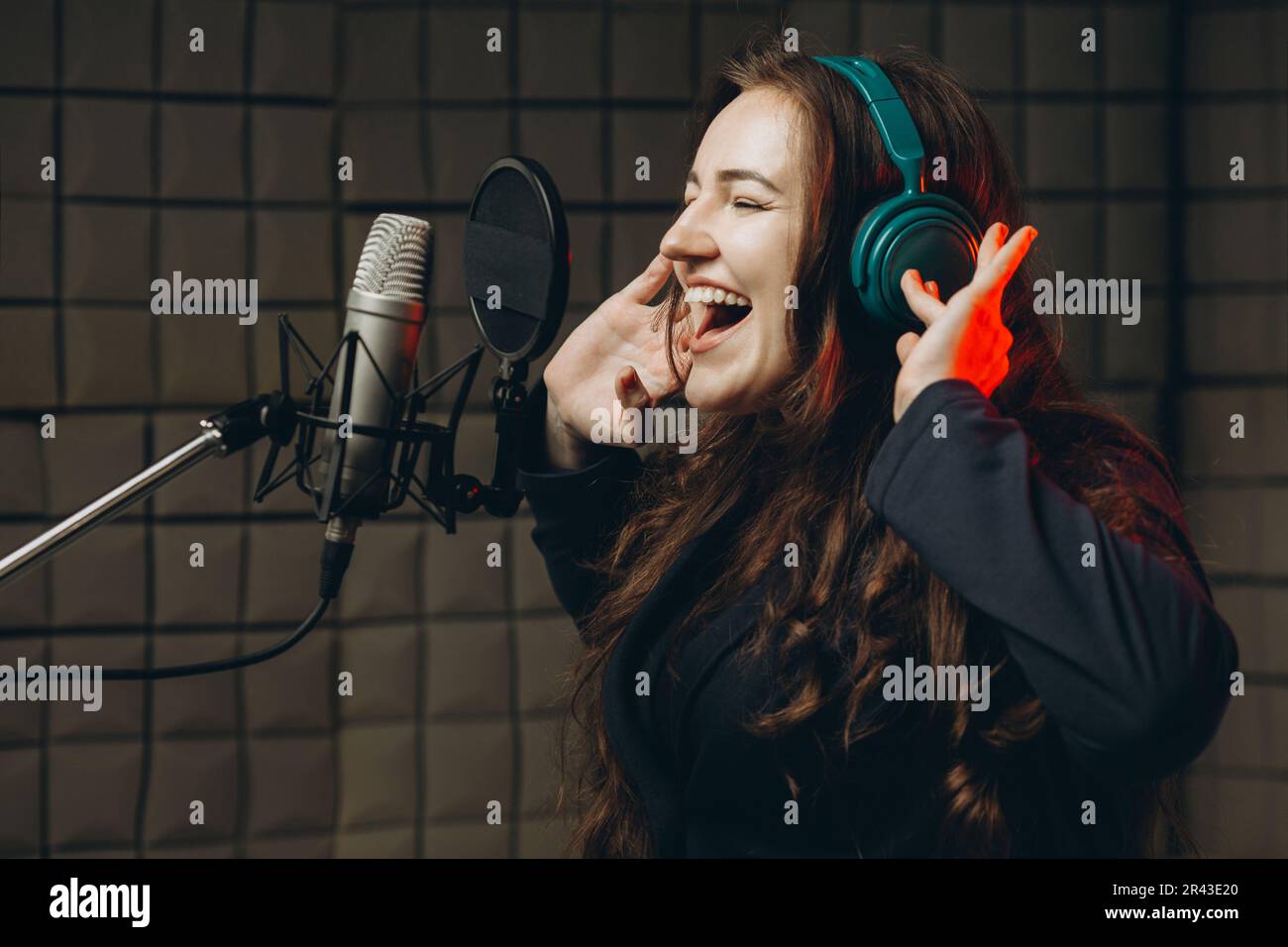 Female person records POP song at the recording studio. Singer ...